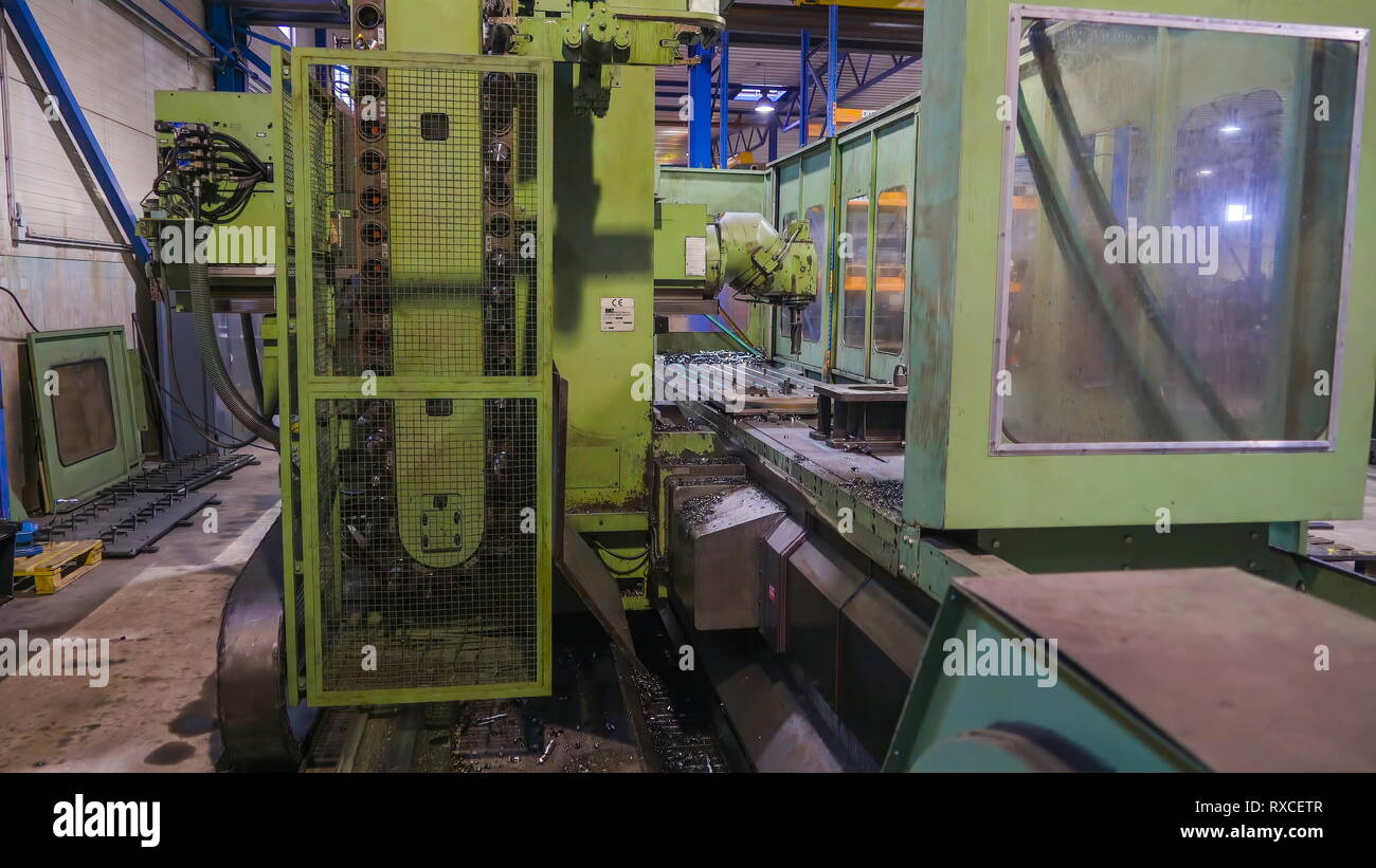 A big machine at work inside the factory. The green machine inside the ...