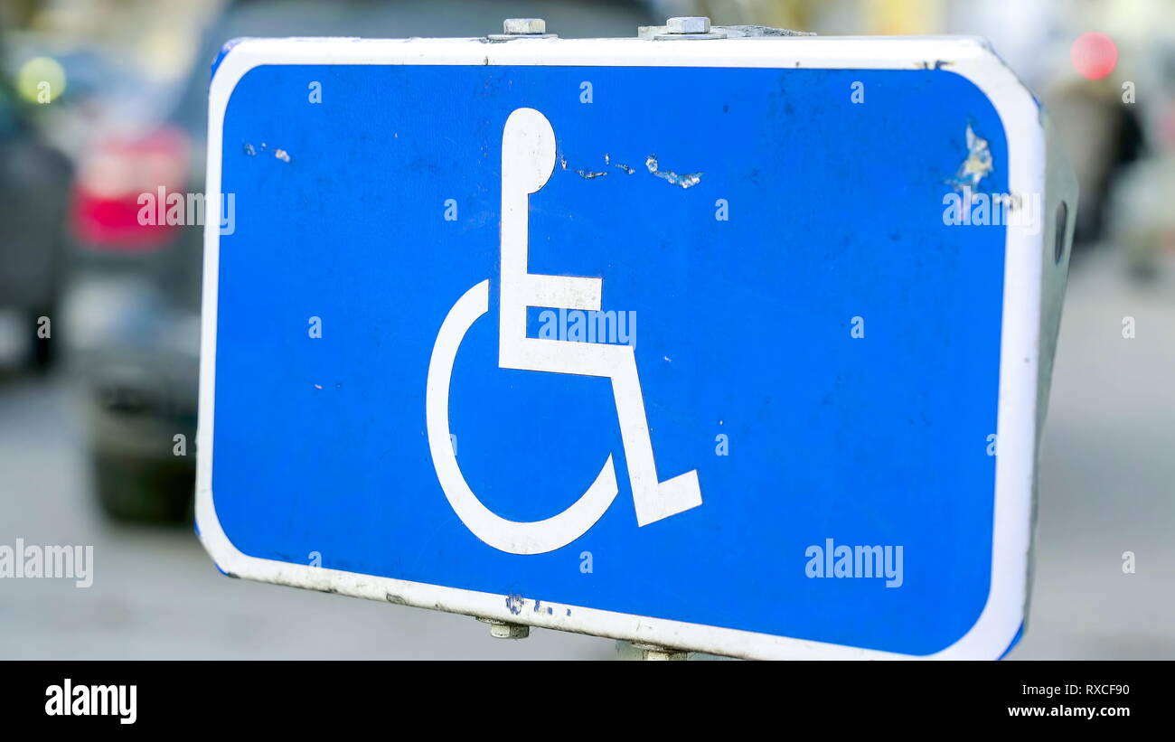 A sign for disable lane. The sign means all disabled can cross the lane ...