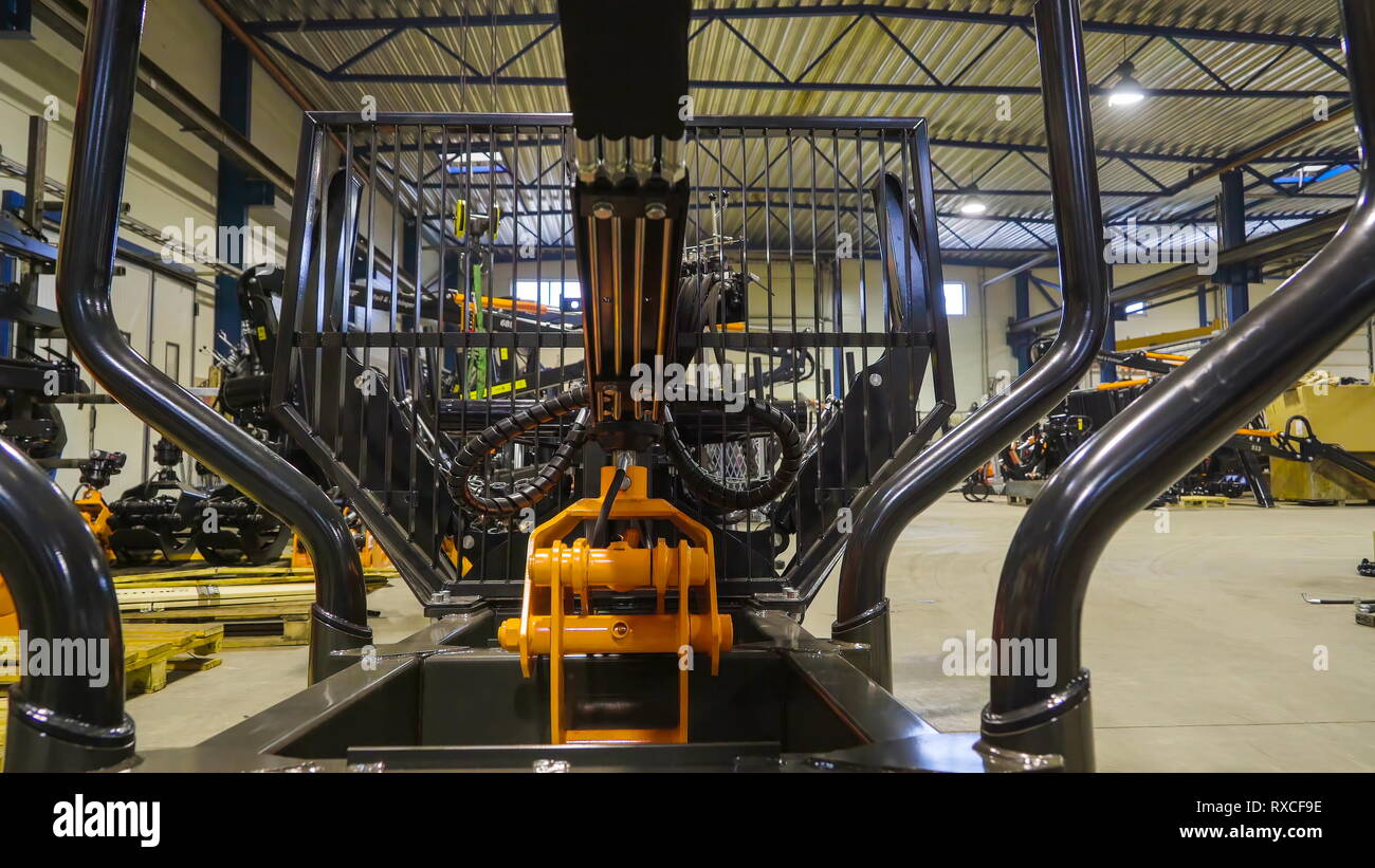 A big log grapper being transported inside the factory of a steel ...