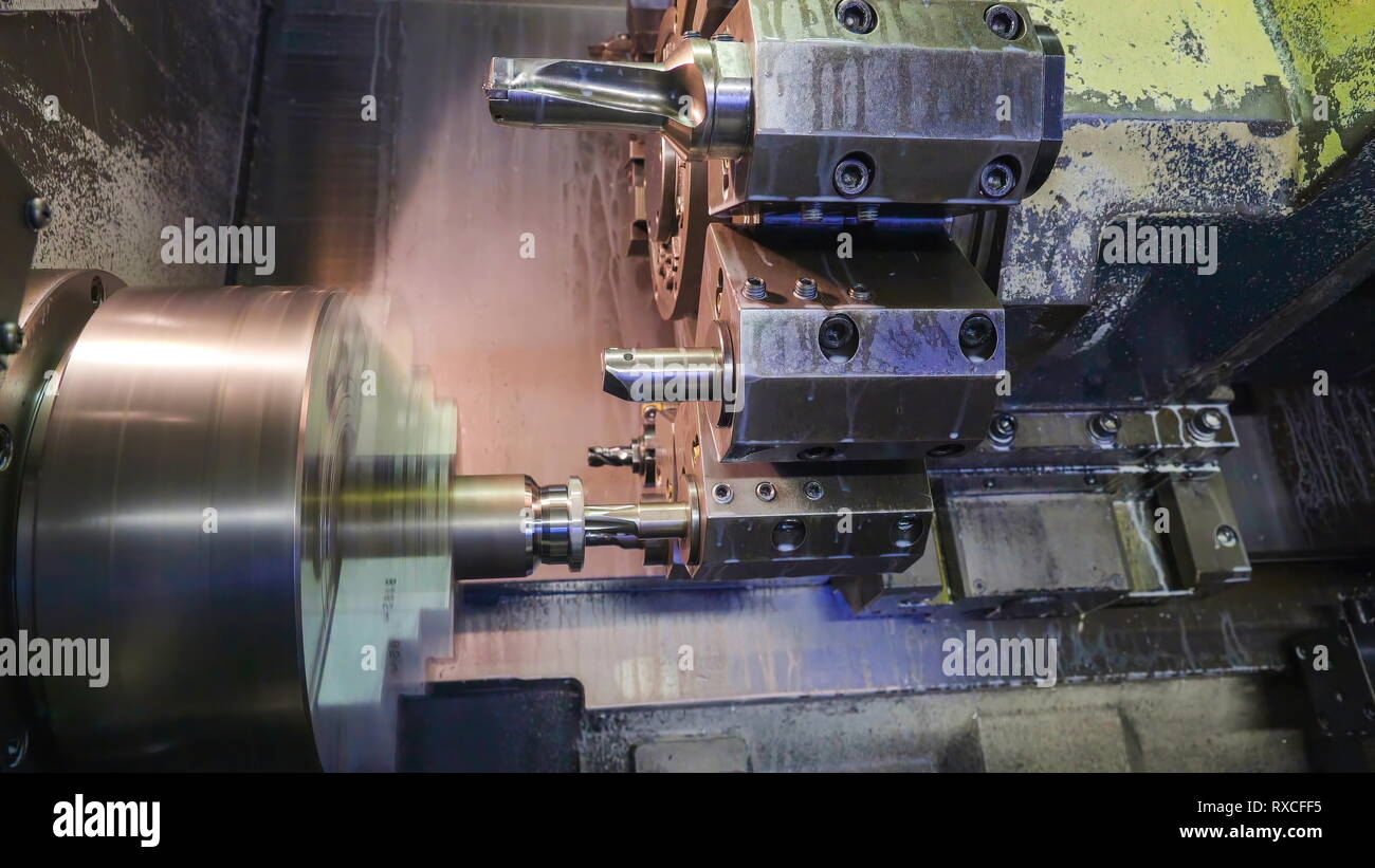 A big turning machine with different drill bits making a hole on the ...