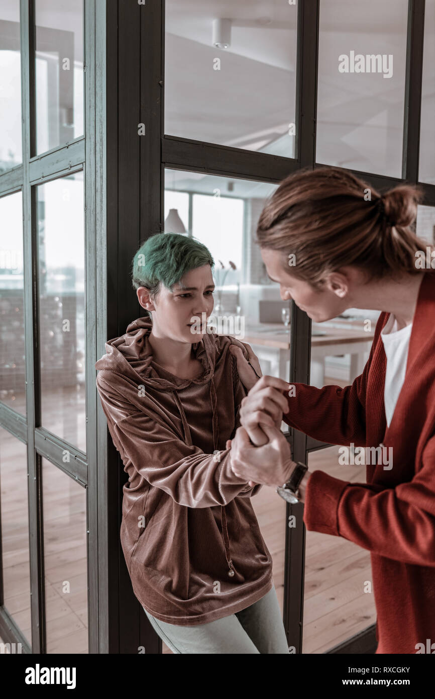 Tender woman crying while suffering from aggression of her man Stock ...