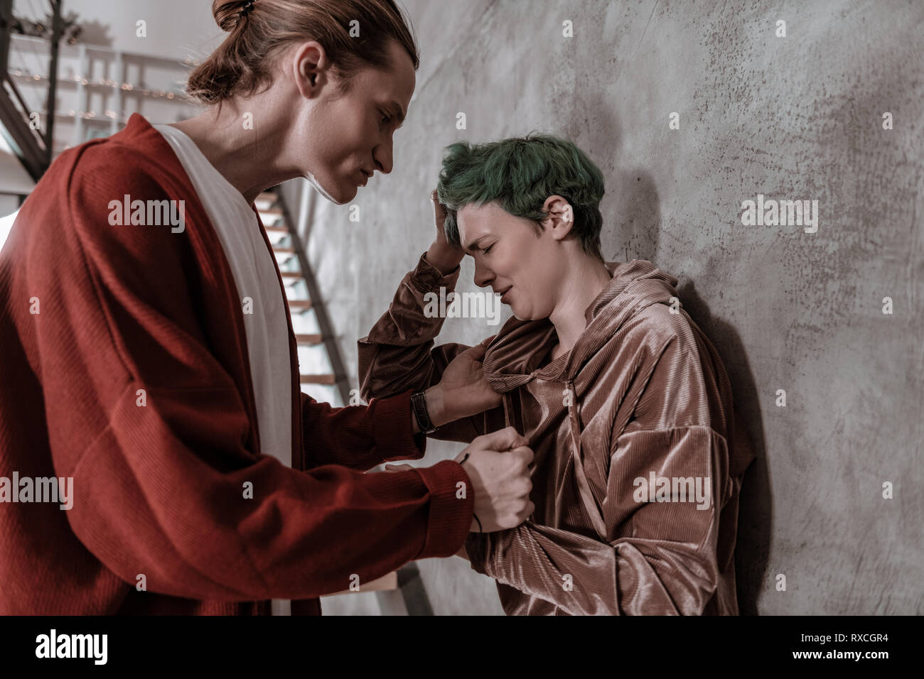 Woman having headache after another hit by boyfriend Stock Photo - Alamy