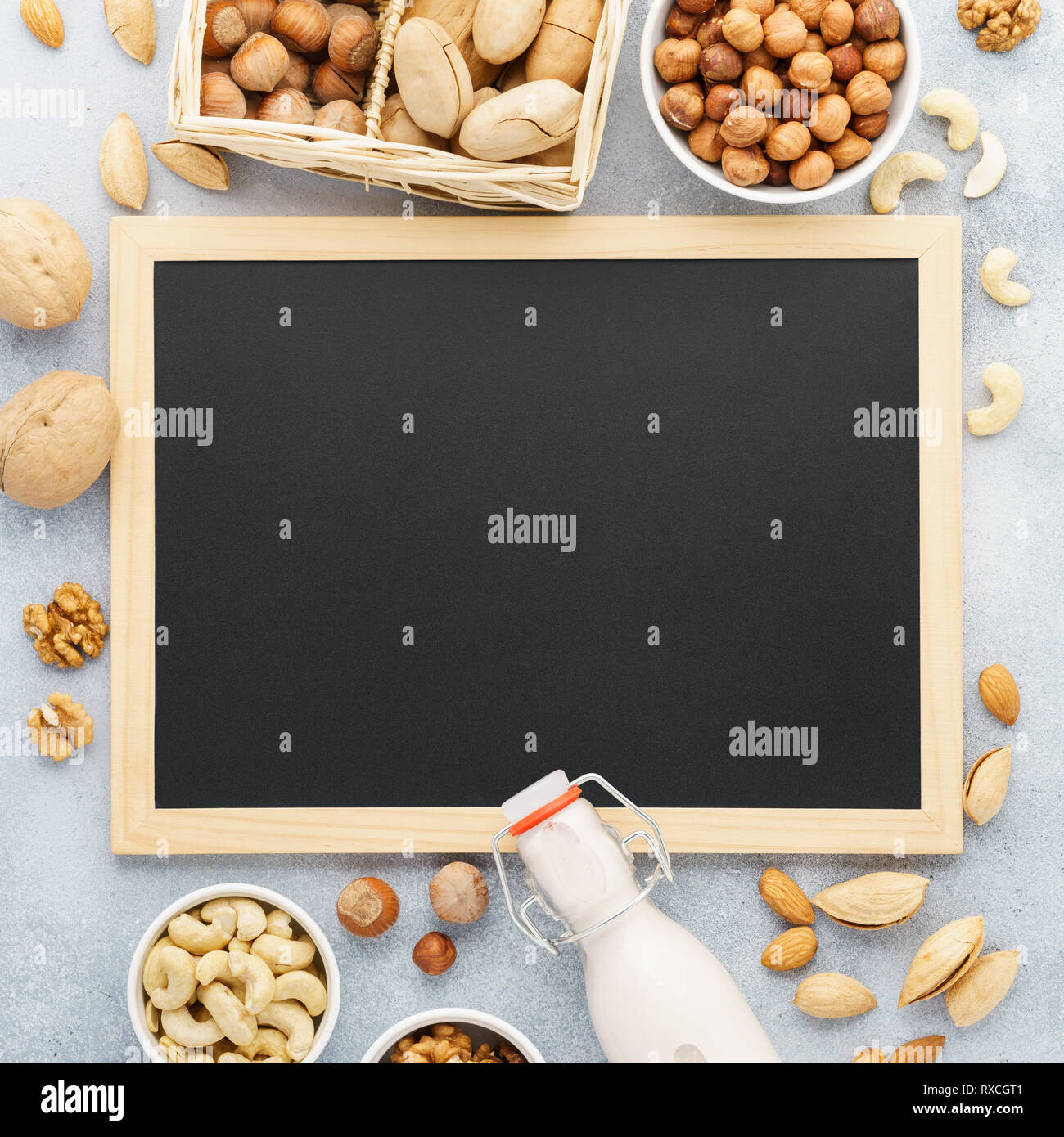 Nut milk and various nuts around chalkboard. Vegan dairy free, no ...