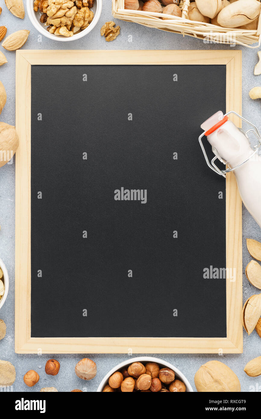 Nut milk and various nuts around chalkboard. Vegan dairy free, no ...