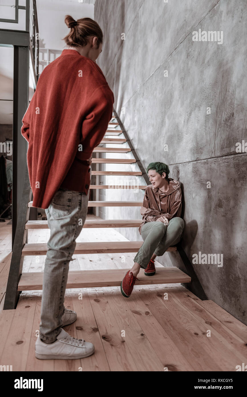 Boyfriend coming home and seeing his girlfriend crying Stock Photo - Alamy