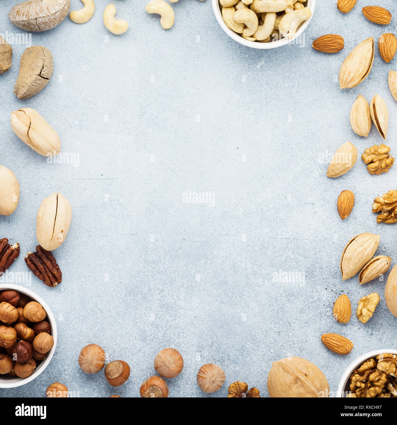 Frame made of different raw nuts. Background with copy space. Top view ...
