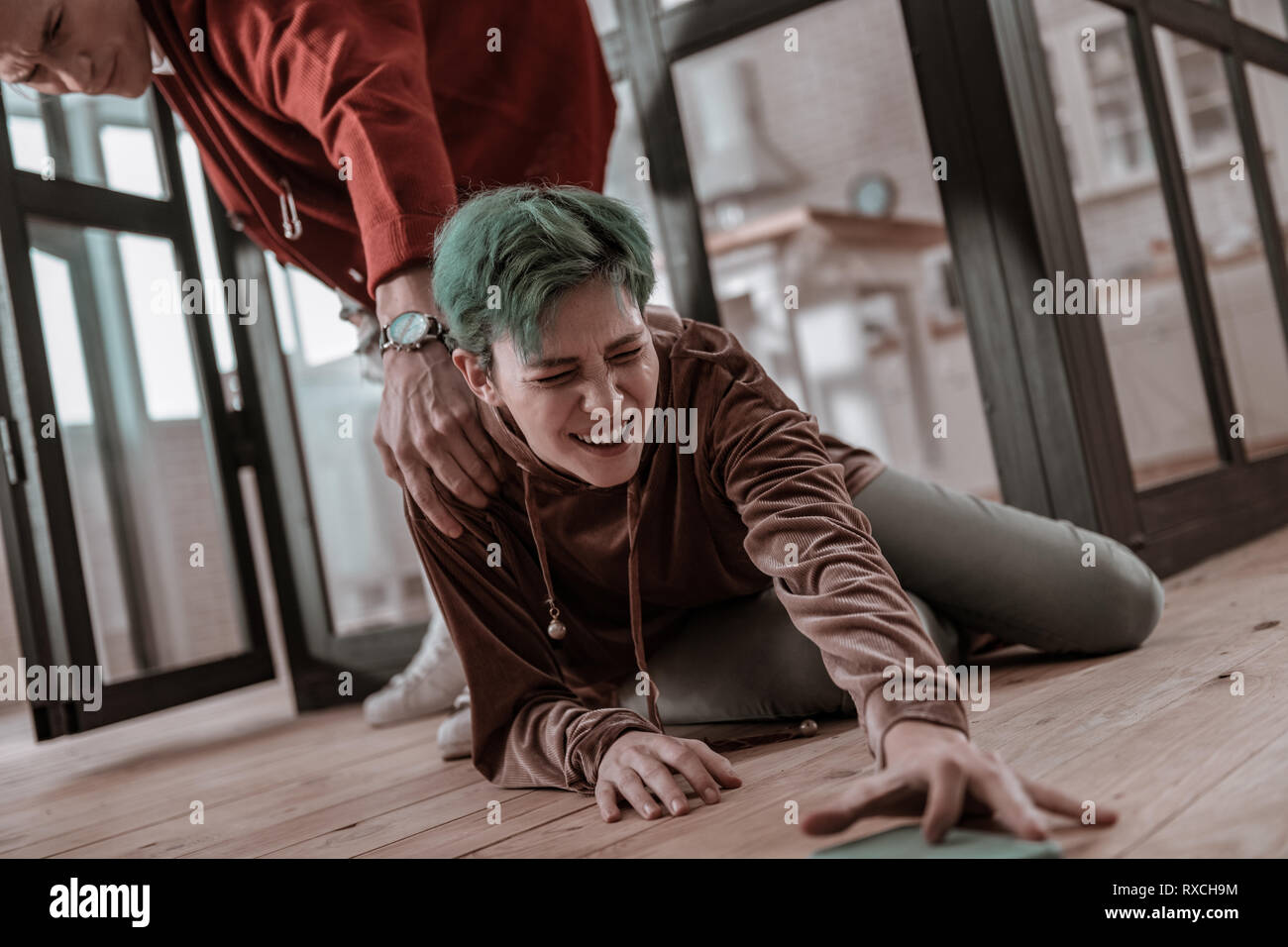 Crying woman trying to take phone and call the police Stock Photo - Alamy