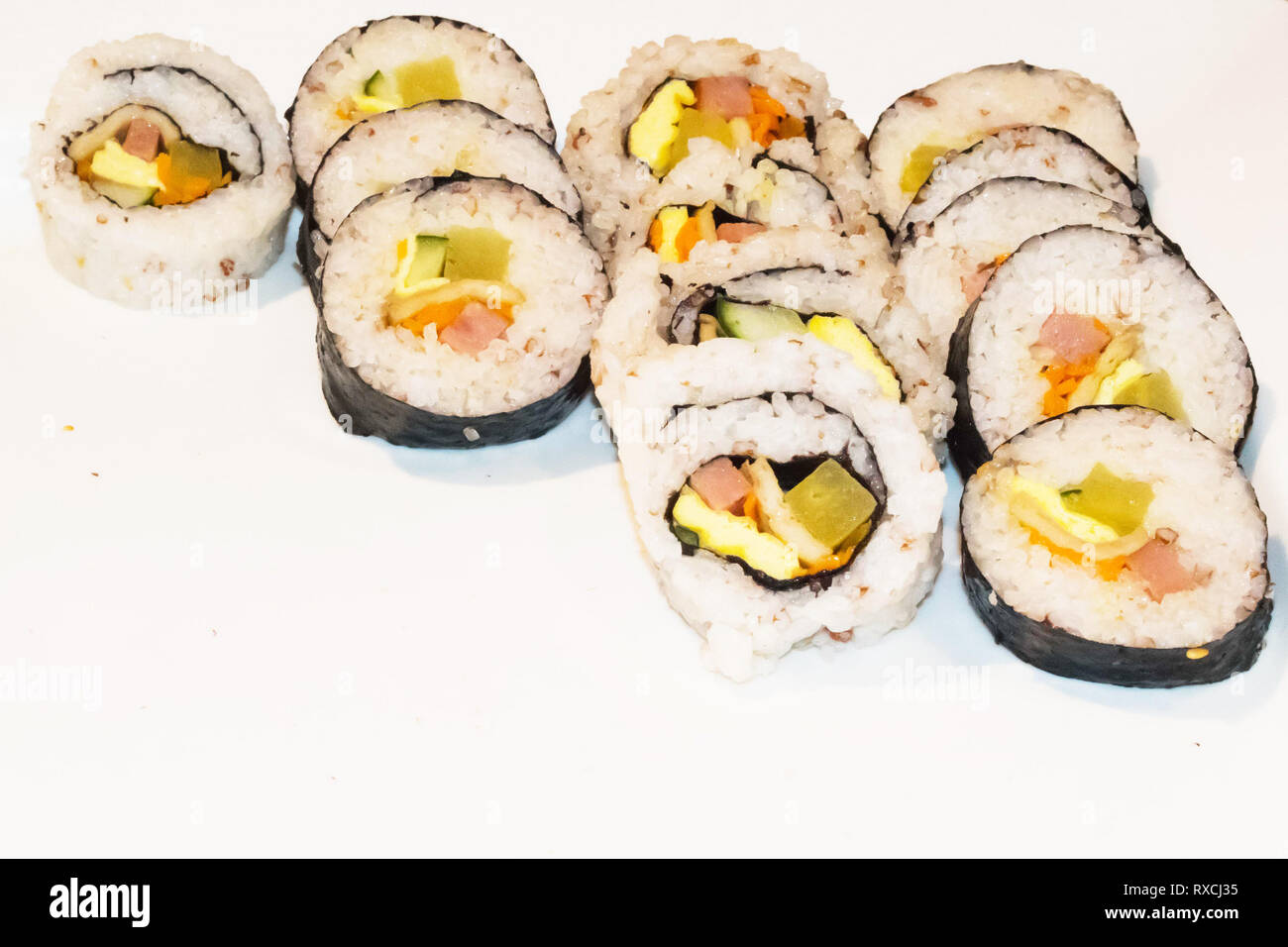 Korean, japanese sushi placed on a white background arranged in rows ...
