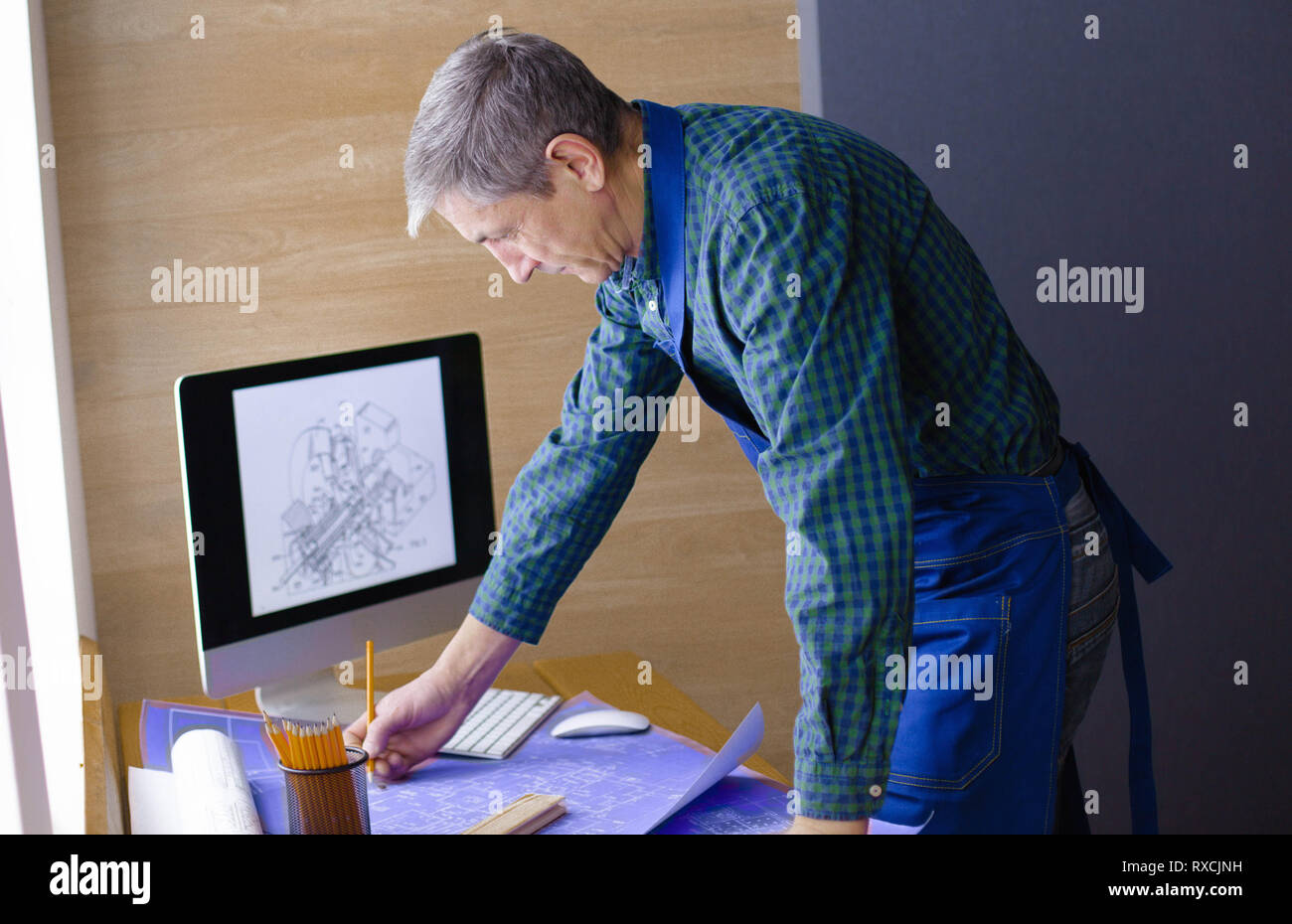 Engineer carpenter working on laptop and sketching project Stock Photo ...
