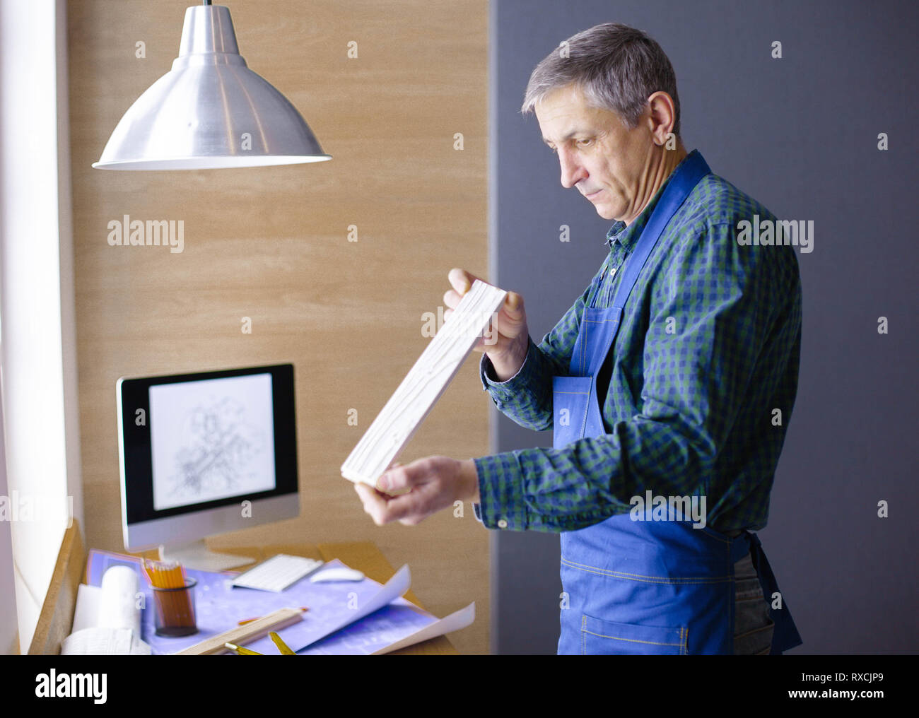 Engineer carpenter working on laptop and sketching project Stock Photo ...
