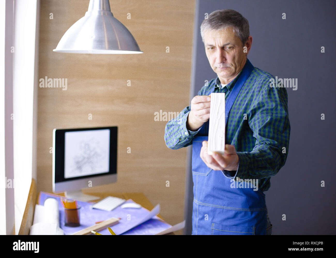 Engineer carpenter working on laptop and sketching project Stock Photo ...
