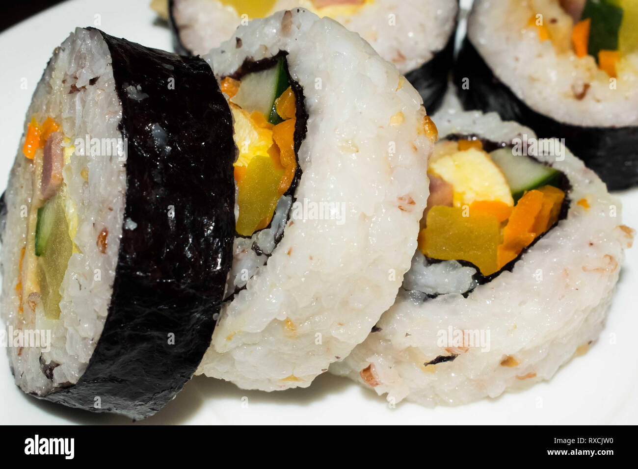 Sushi wrapped in rice only and the other wrapped in rice and seaweed ...