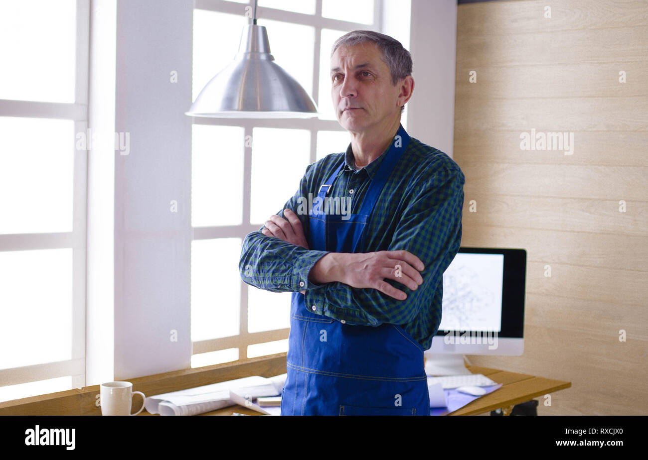 Engineer carpenter working on laptop and sketching project Stock Photo ...