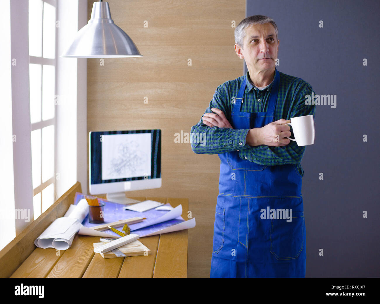 Engineer carpenter working on laptop and sketching project Stock Photo ...