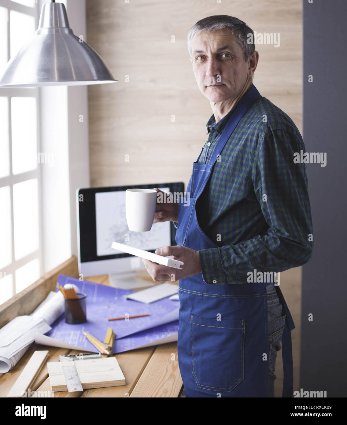 Engineer carpenter working on laptop and sketching project Stock Photo ...