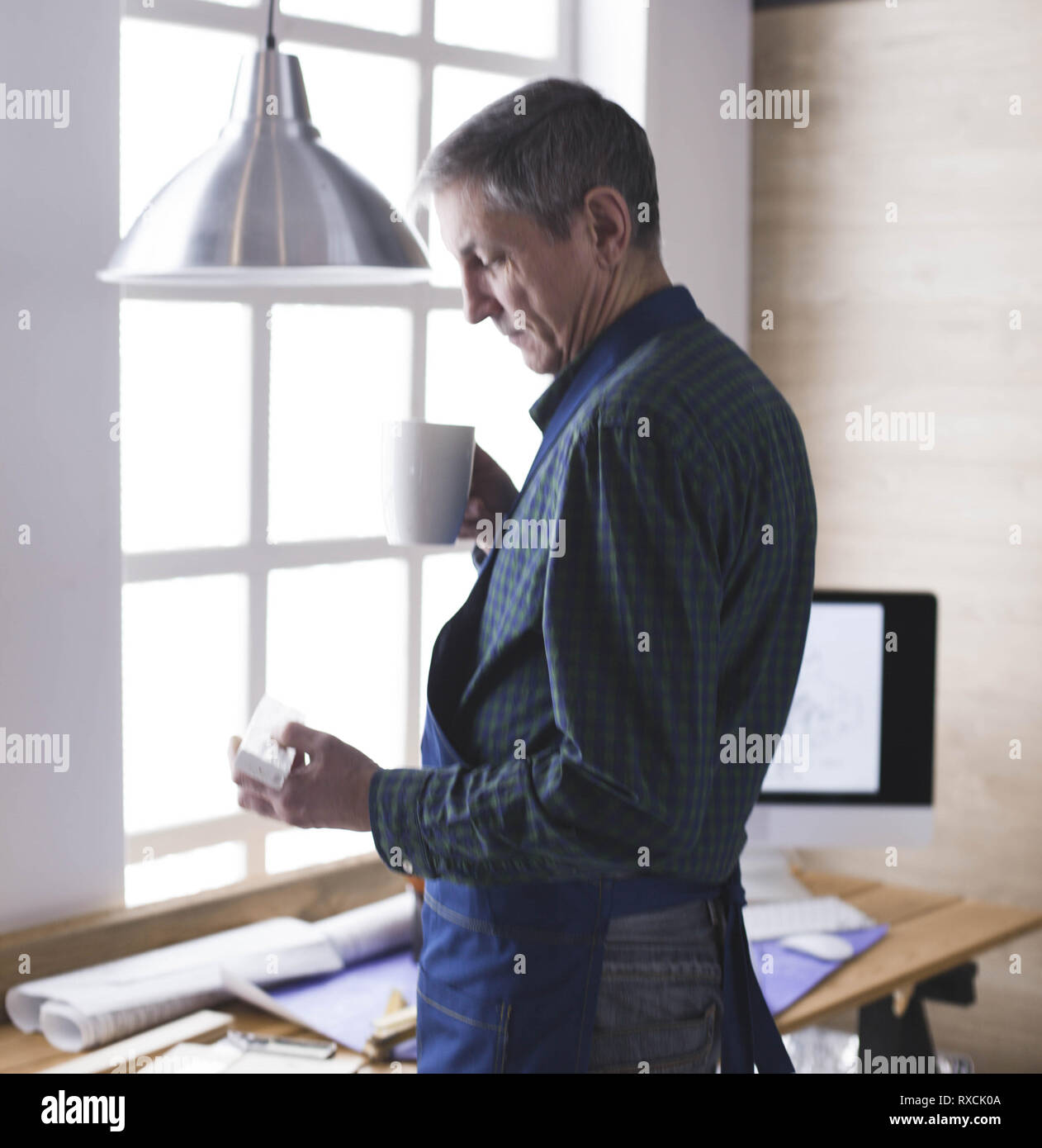 Engineer carpenter working on laptop and sketching project Stock Photo ...
