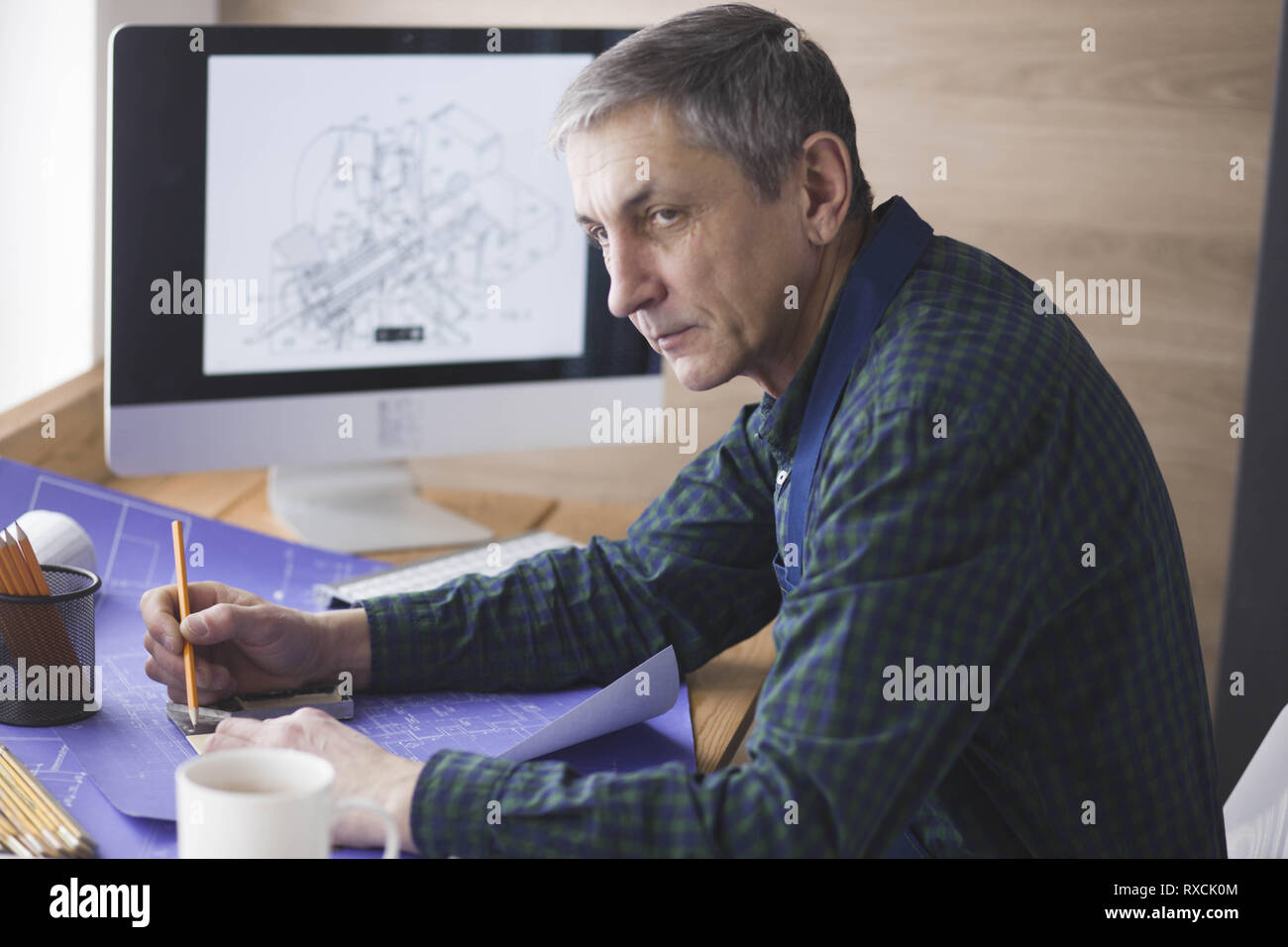 Engineer carpenter working on laptop and sketching project Stock Photo ...