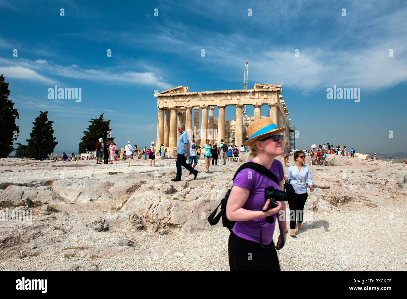 Tourists in front of the Parthenon, an ancient Greek temple dedicated ...