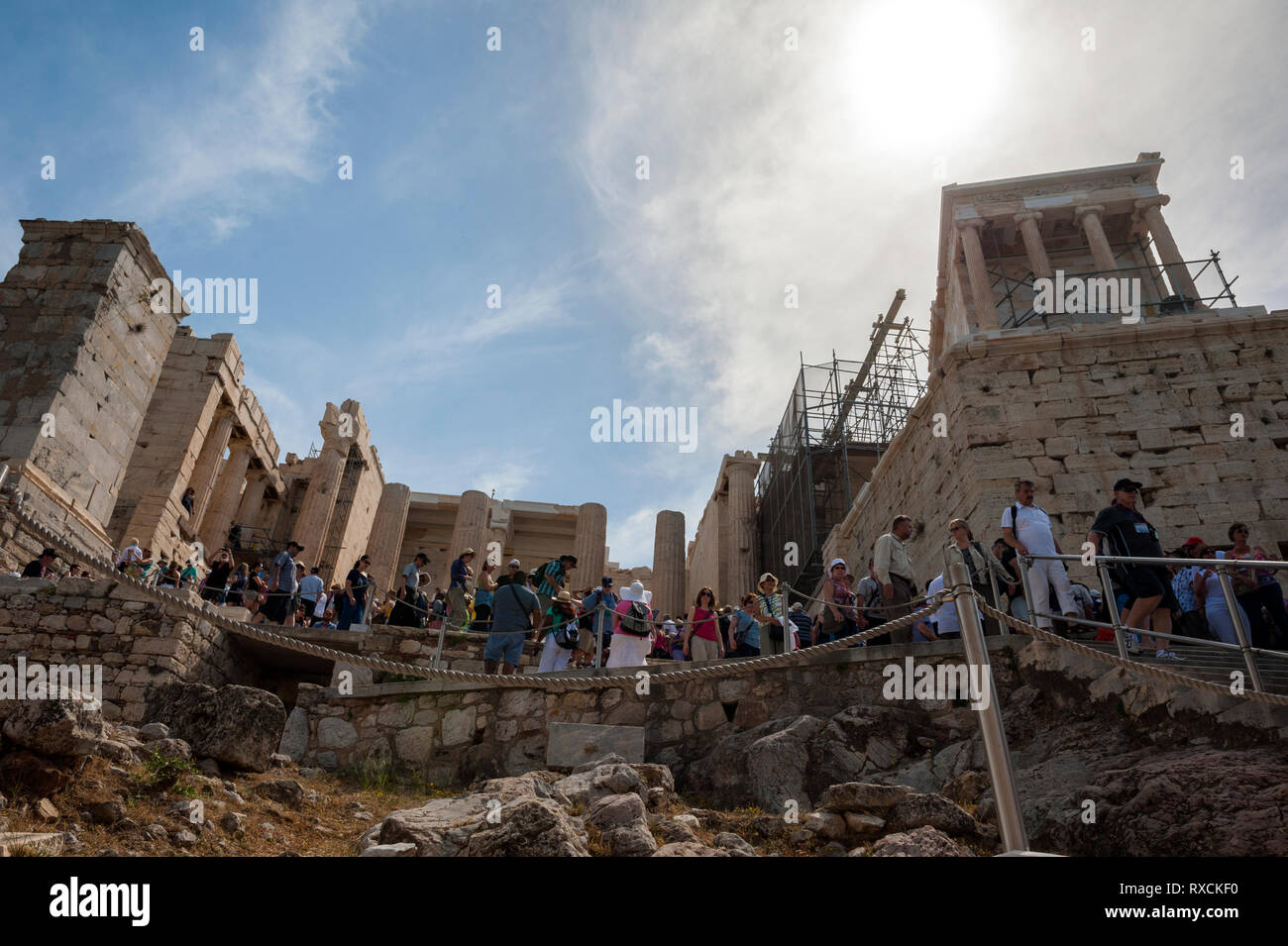 Tourists on the stairs going up to the Propylaea, the entrance to the ...