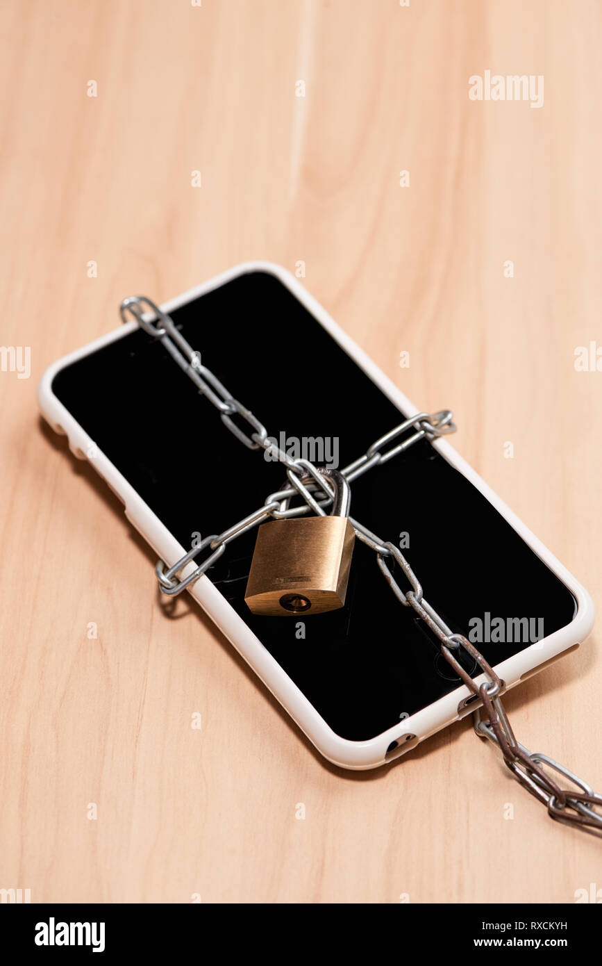 Security of smartphone, tied chain with lock Stock Photo - Alamy