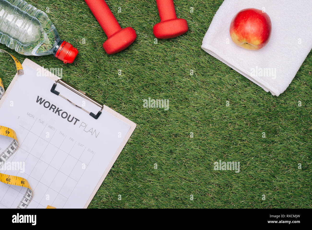 Sheet of paper and sports equipment on grass close-up Stock Photo - Alamy