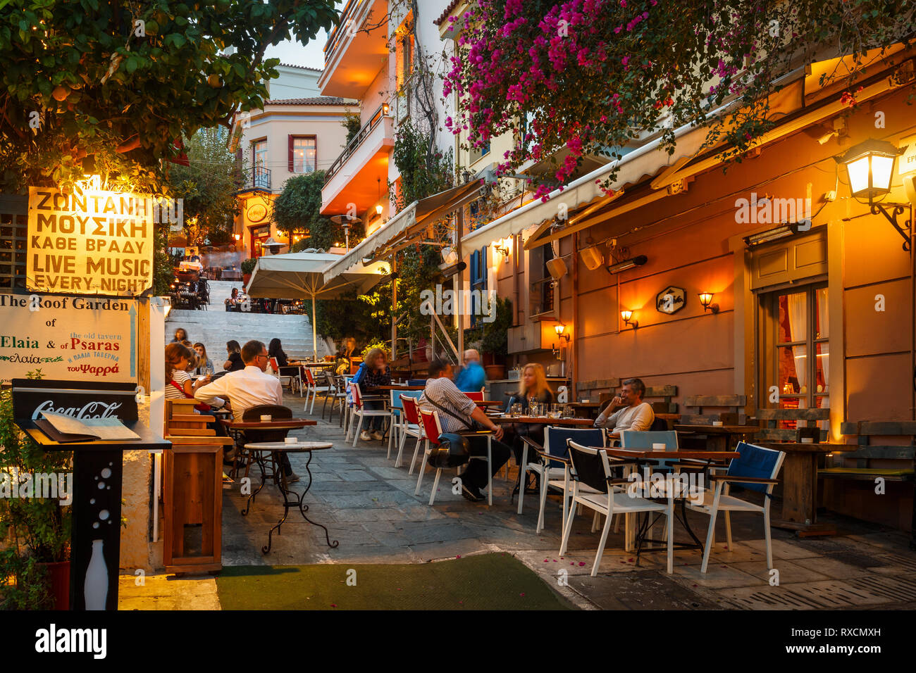 Athens, Greece - October 31, 2018: Coffee shops in the old town of Athens just under Acropolis ...