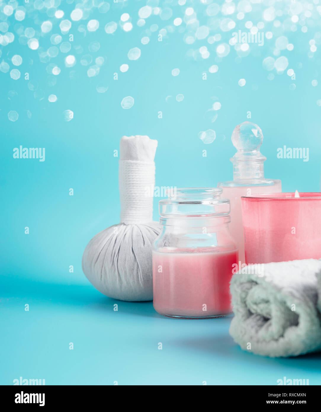 Cosmetic with towel and massage stamp for spa treatment at light blue ...