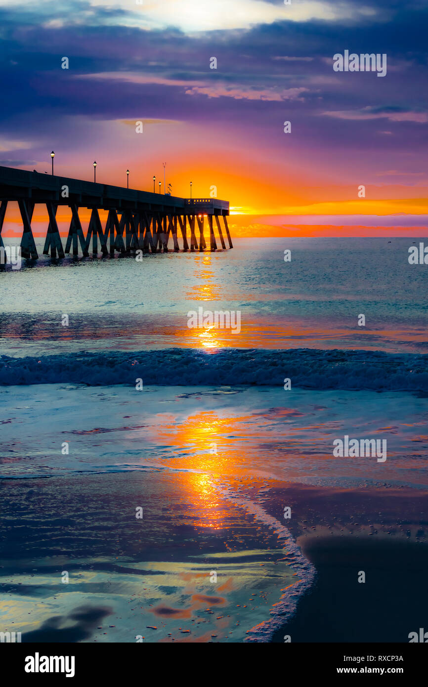 Sunrise over Atlantic Ocean colliding with a full moon in the west ...