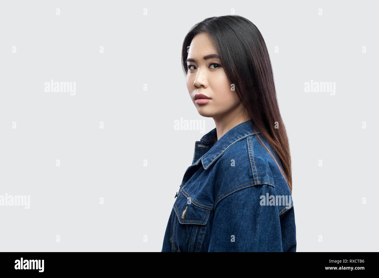 Profile side view portrait of calm serious beautiful brunette asian ...