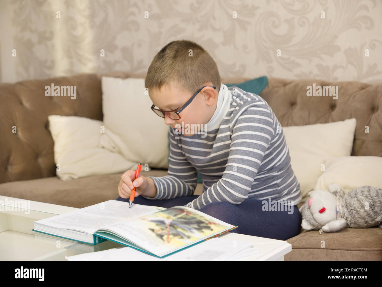 young boy learns to read a big book Stock Photo - Alamy