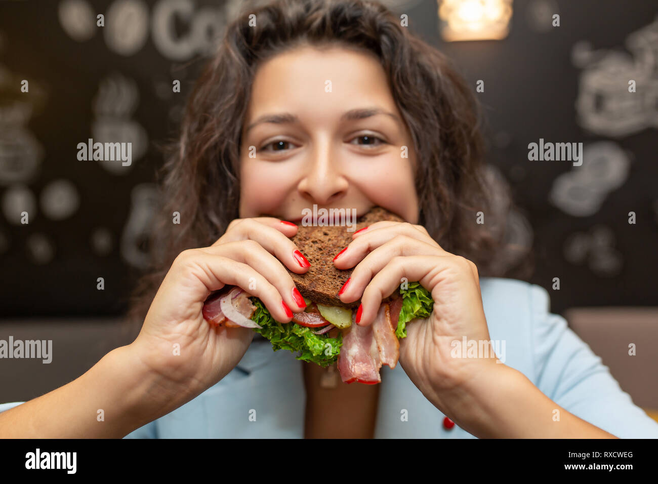 Closeup portrait of hungry young caucasian woman, bite sandwich Stock ...