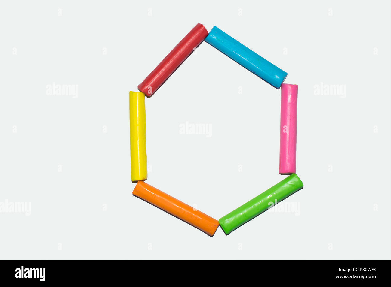 Clay sticks forming a hexagon on a white background Stock Photo - Alamy