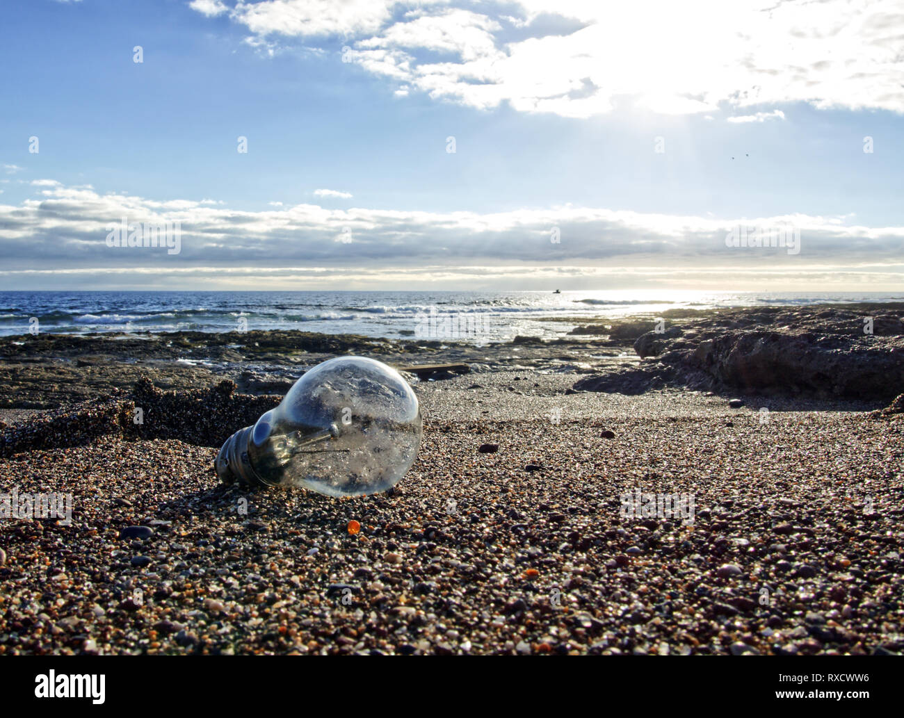 old light bulb on the beach Stock Photo - Alamy