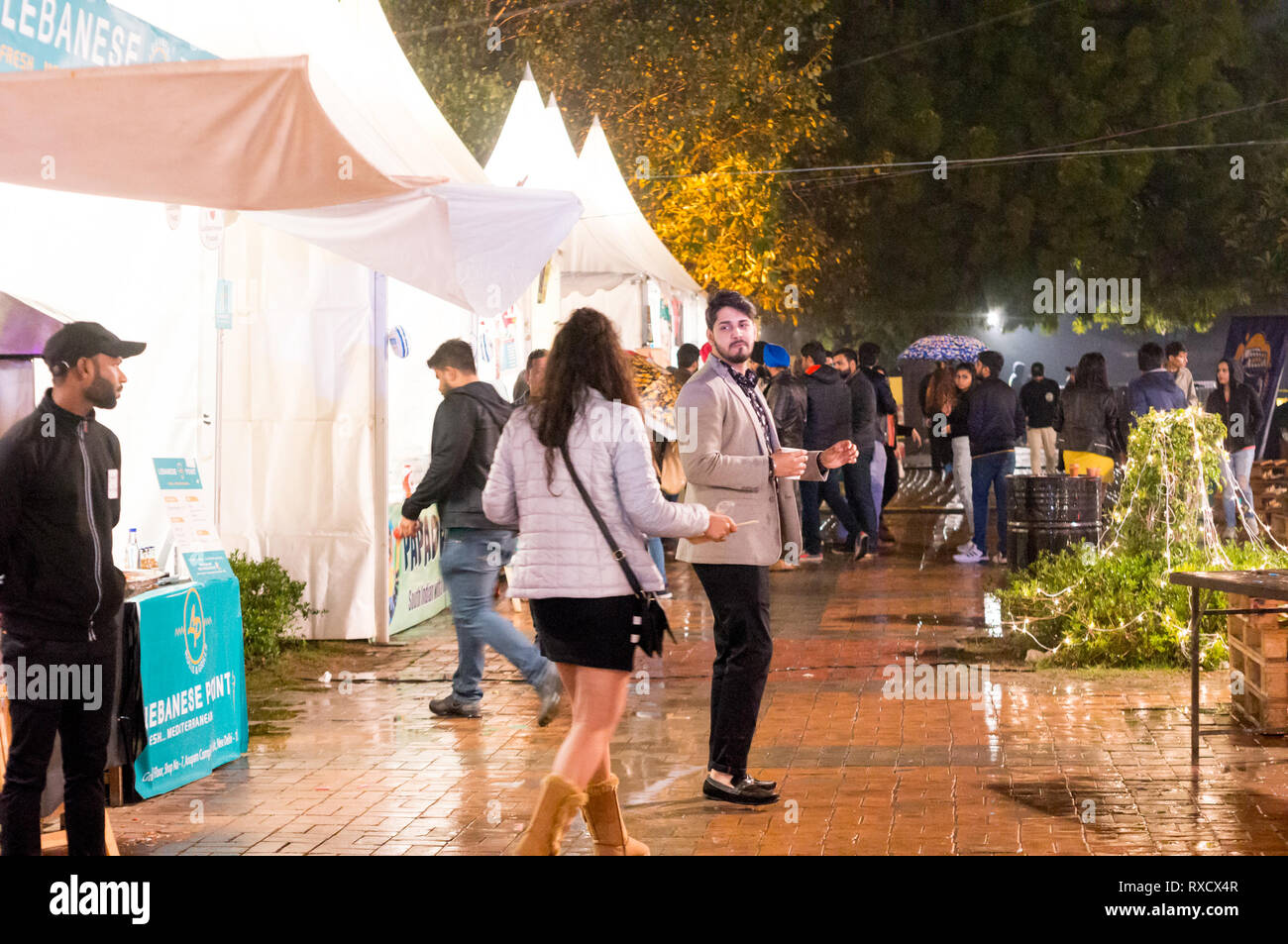 People roaming around shopping from open tents Stock Photo - Alamy