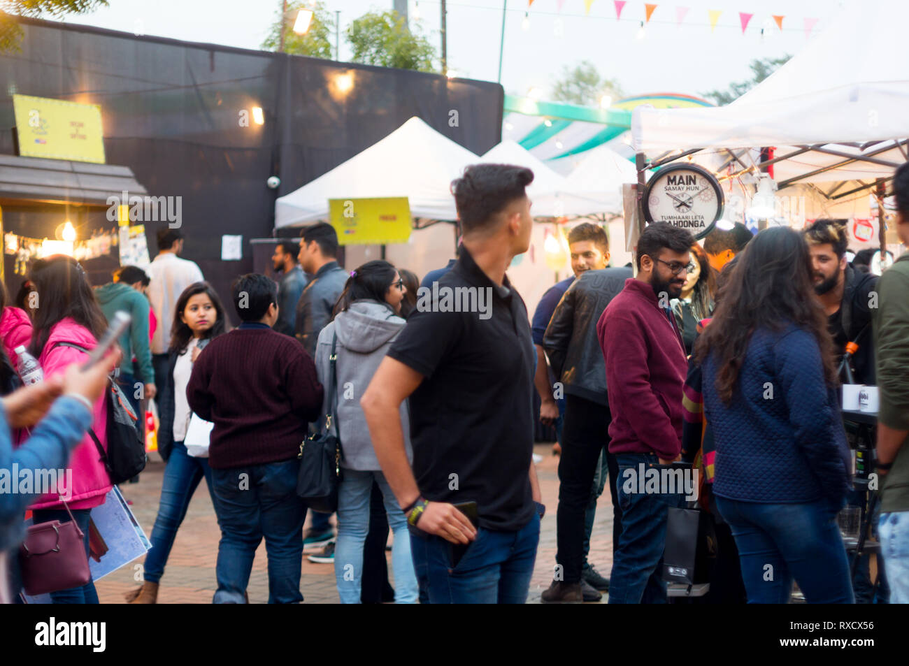 People roaming around shopping from open tents Stock Photo - Alamy