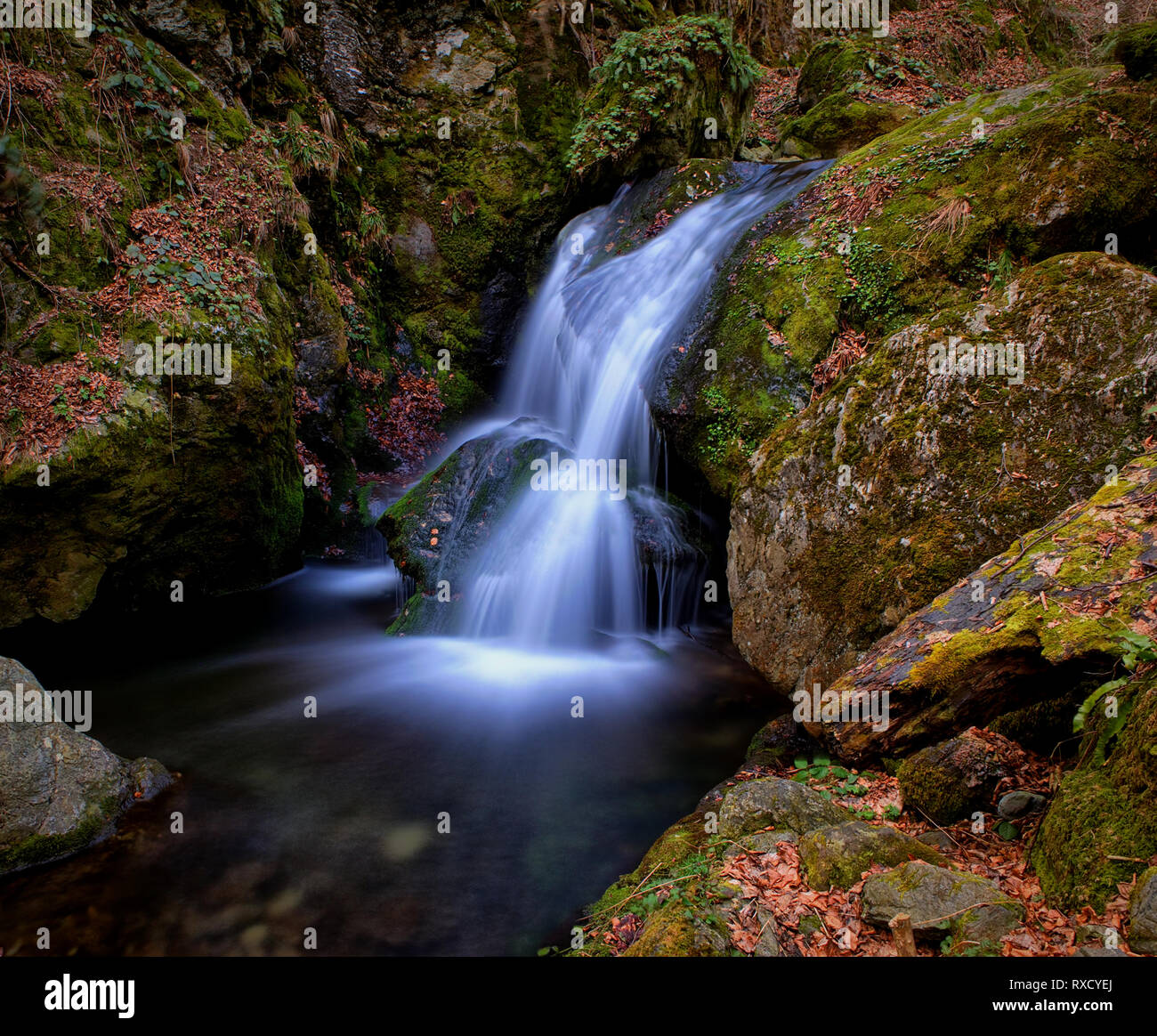 Smooth waterfall and colorful rocks in autumn Stock Photo - Alamy