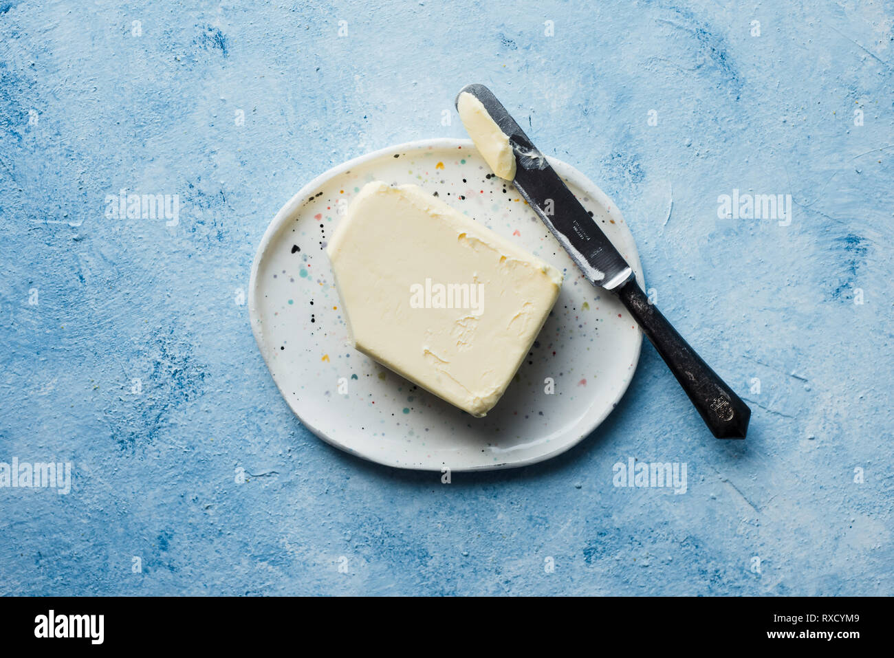 Block of butter with an old knife on a handmade plate Stock Photo - Alamy