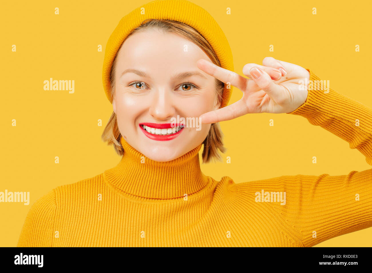 Young beautiful woman on yellow background smiling with happy face ...