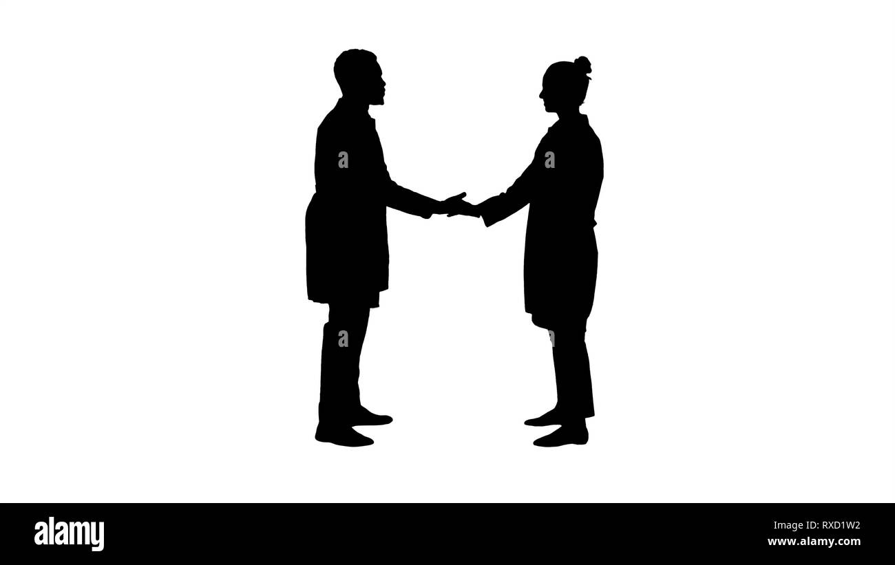 Silhouette Successful team of surgeons giving high five and laughing ...