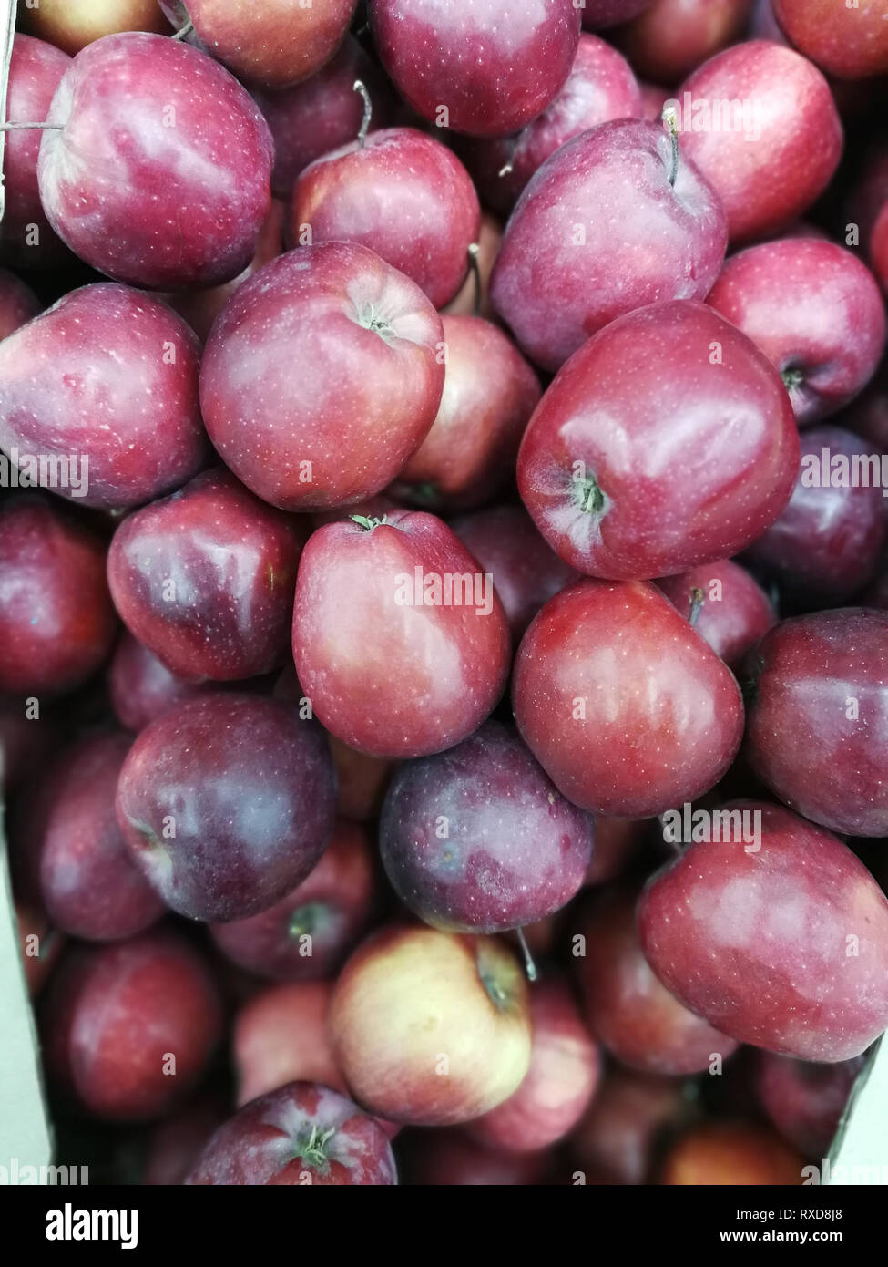 Red apples on red satin fabric, background Stock Photo - Alamy