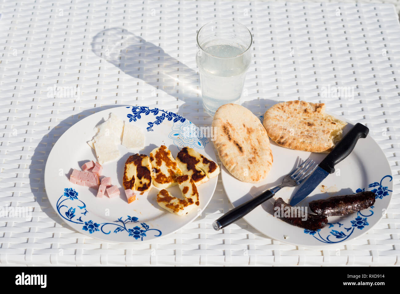 Breakfast set of halloumi, ham, wine sausage and pita bread in local ...