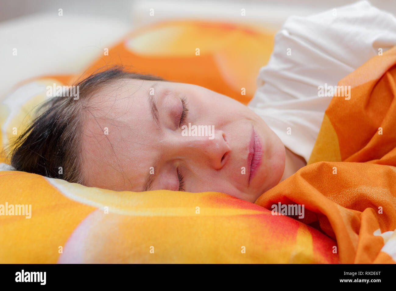 Woman sleeping soundly lying on her right side Stock Photo - Alamy