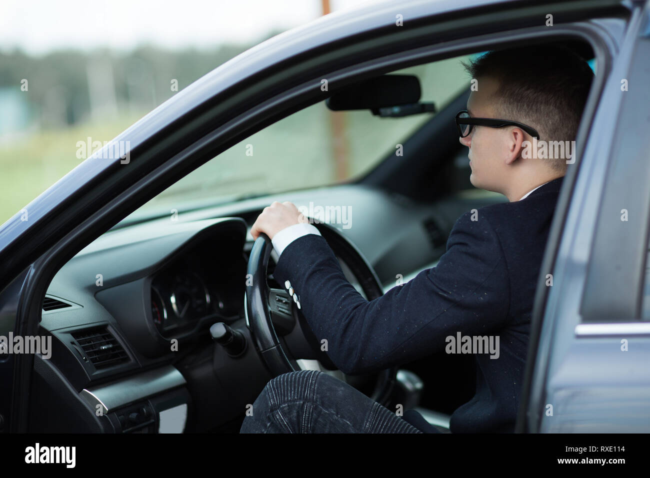 Handsome businessman behind wheel hi-res stock photography and images ...