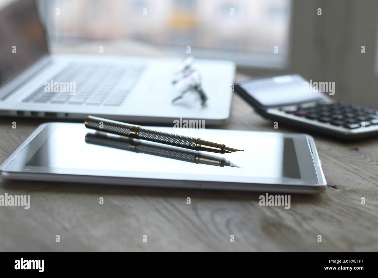 close up.fountain pen, tablet and laptop on the table.business ...