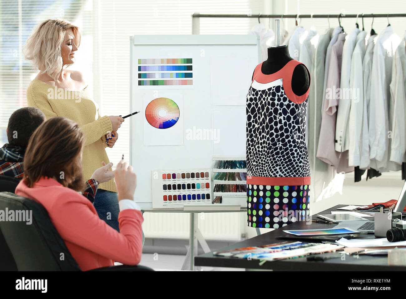 group of designers discussing a new clothing collection Stock Photo - Alamy