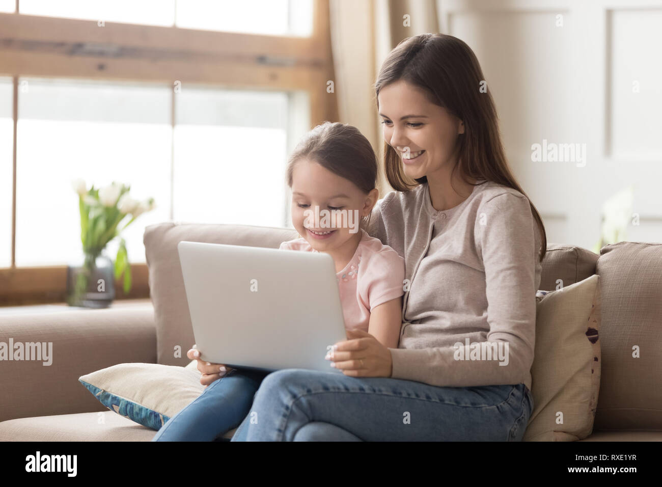 Happy mother and child daughter use laptop computer at home Stock Photo ...