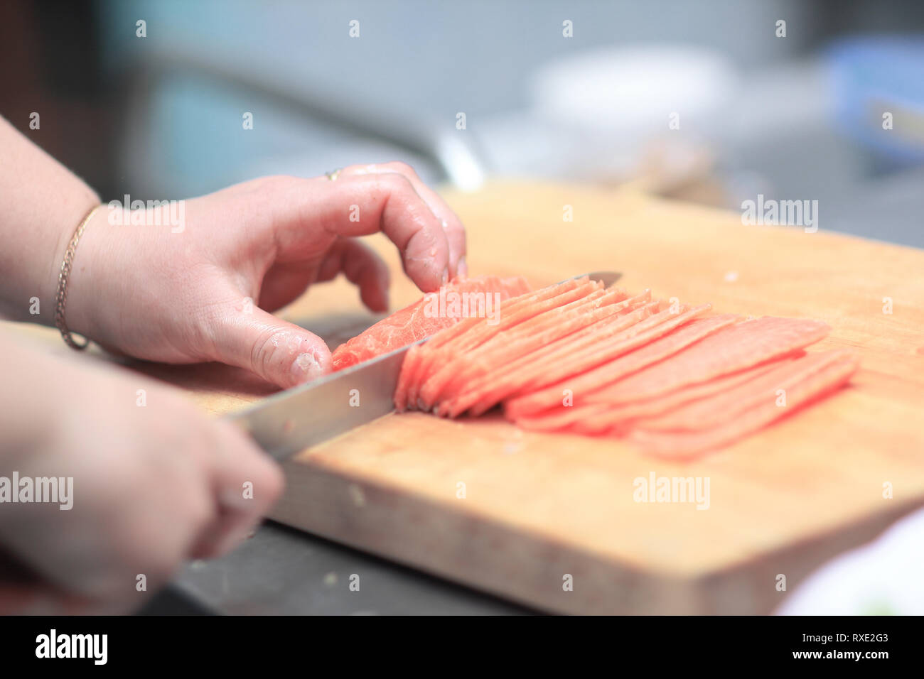 close up. chef slicing fish for sushi Stock Photo - Alamy