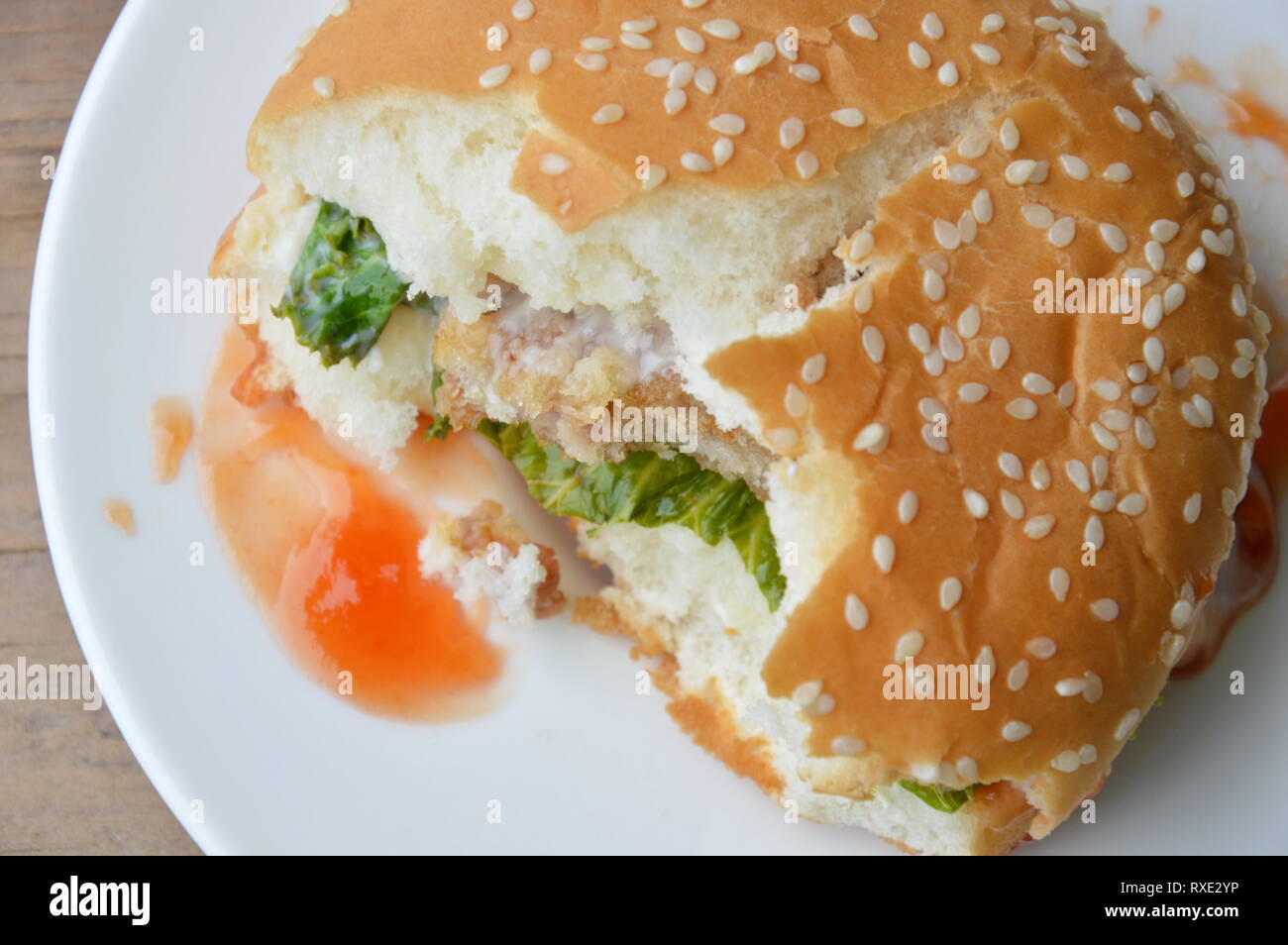 pork hamburger dressing ketchup biting on dish Stock Photo - Alamy