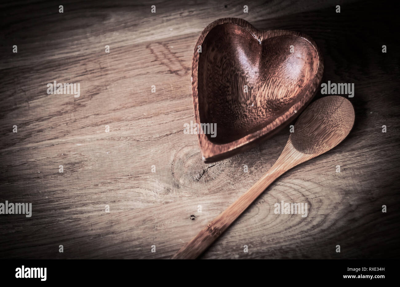 closeup. empty wooden salad bowl and wooden paddle Stock Photo - Alamy