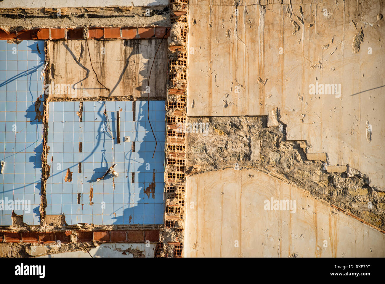 Wall left over after pulling down a house Stock Photo - Alamy